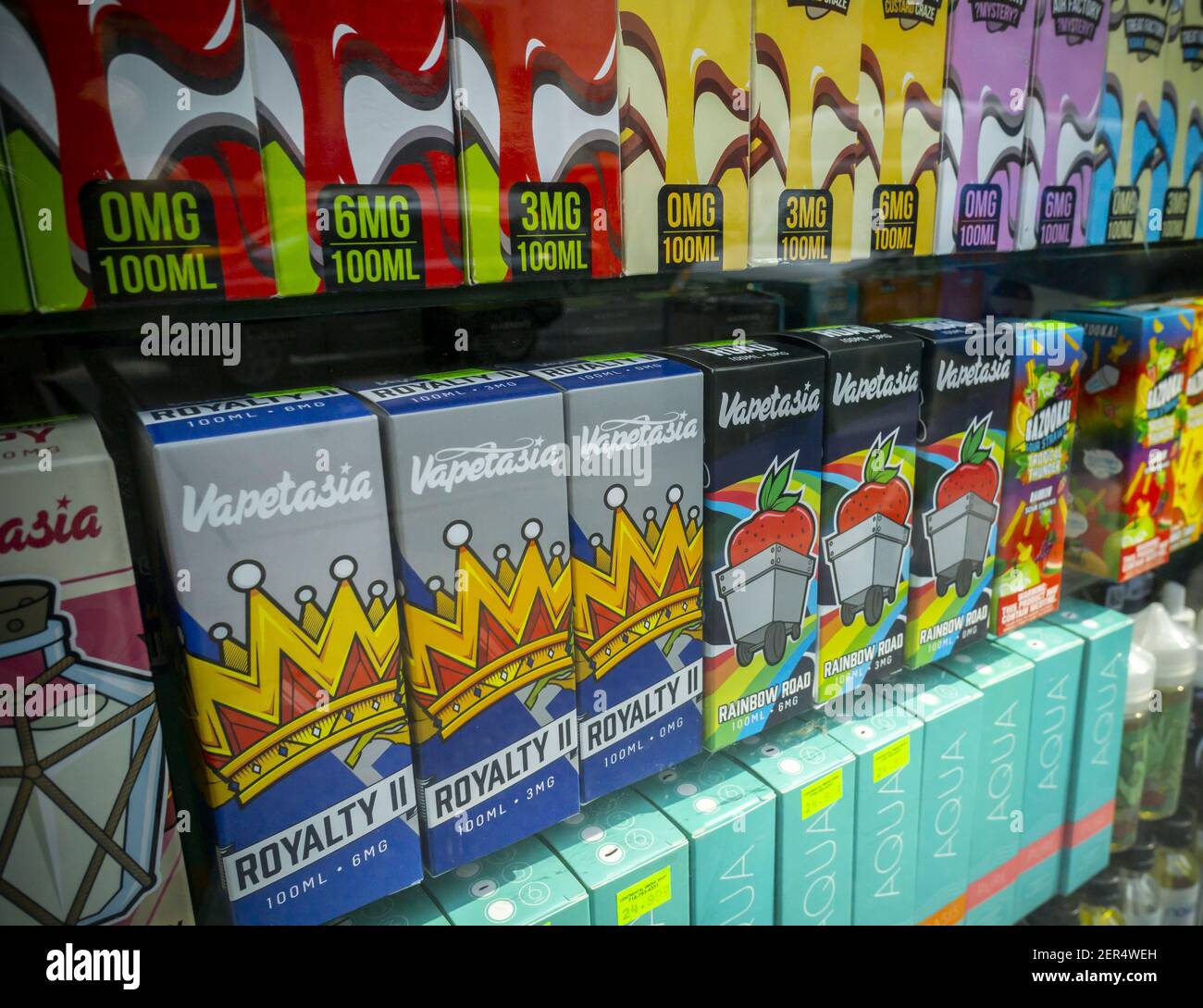 A selection of flavored vaping supplies on display in the window of a ...