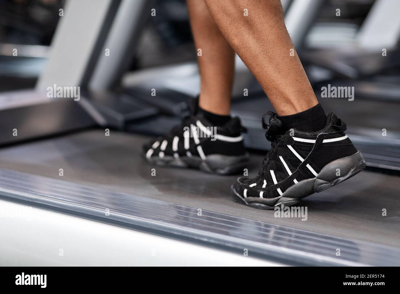 Cropped of african american man legs running by treadmill Stock Photo ...