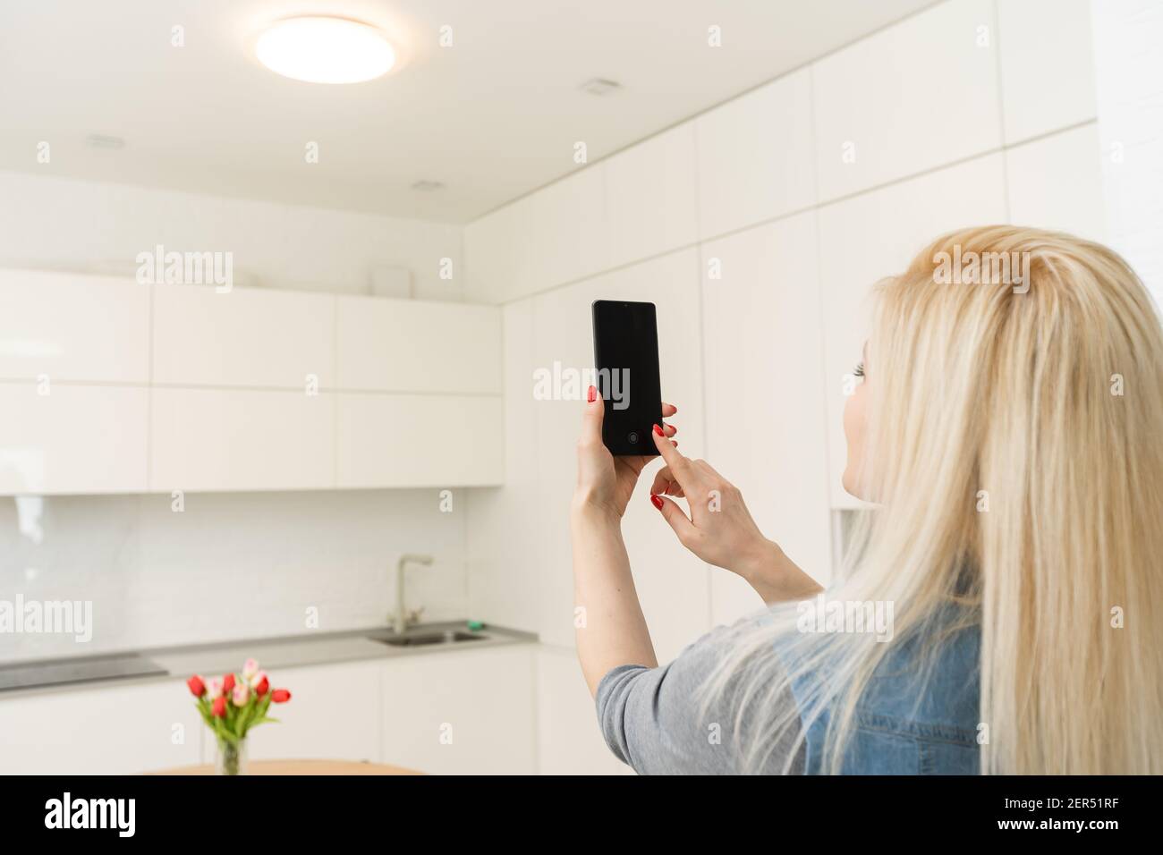Woman using smartohone in smart house, empty screen Stock Photo - Alamy