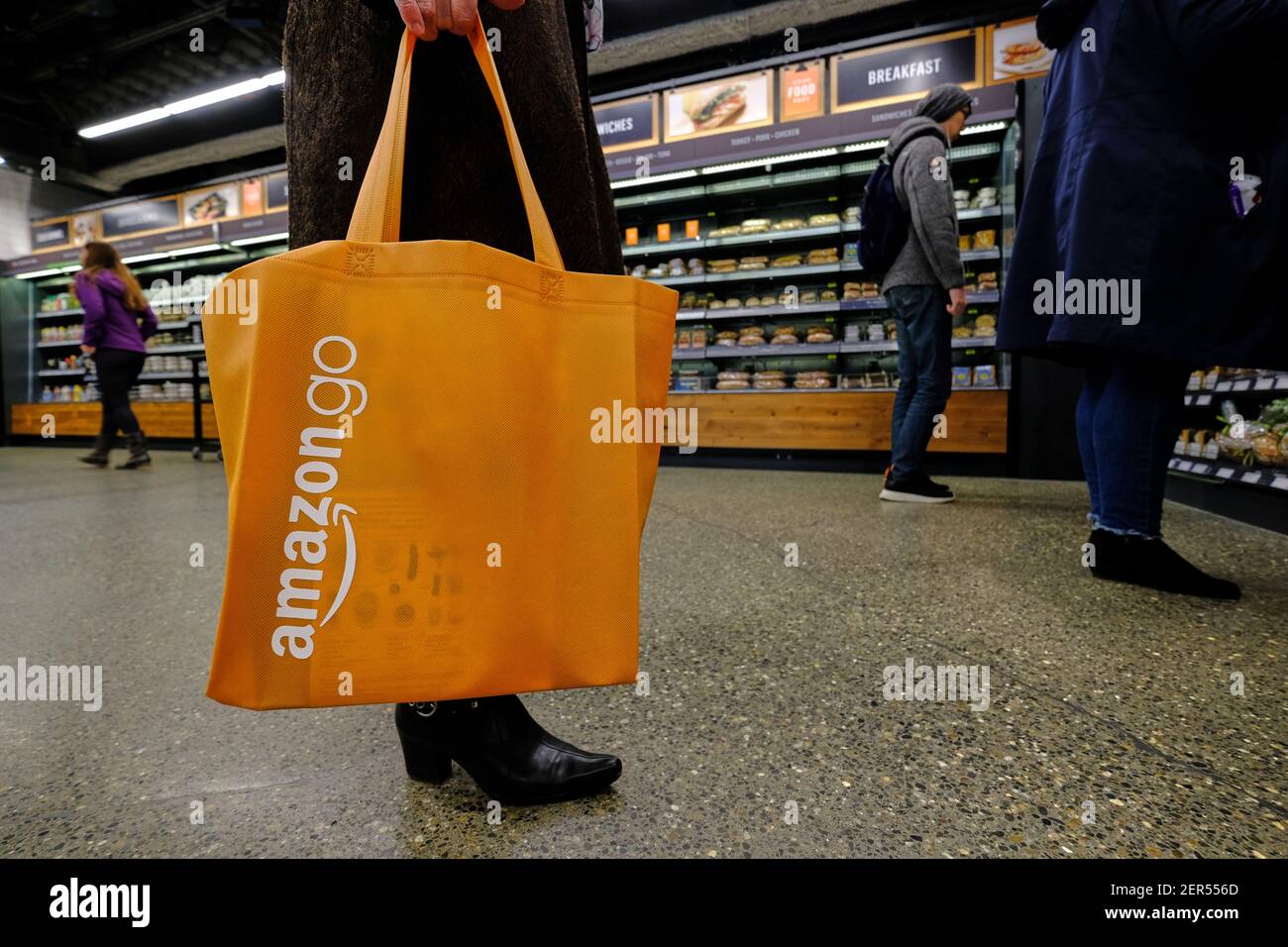 People shop at the Amazon Go store in Seattle, Wash., on April 18, 2018 ...