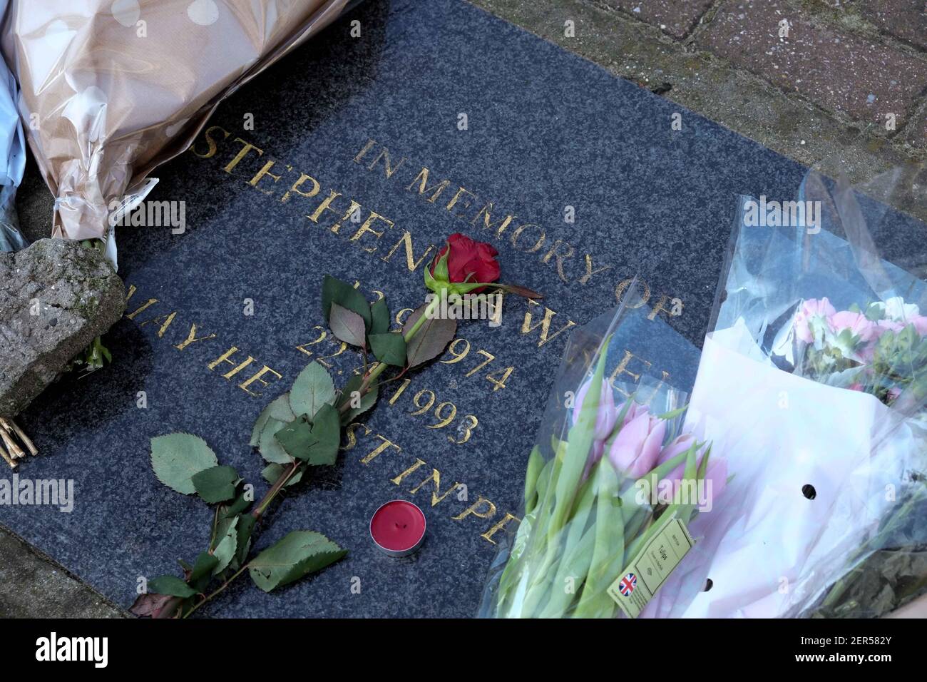Floral tributes are left on the memorial stone of Stephen Lawrence on ...