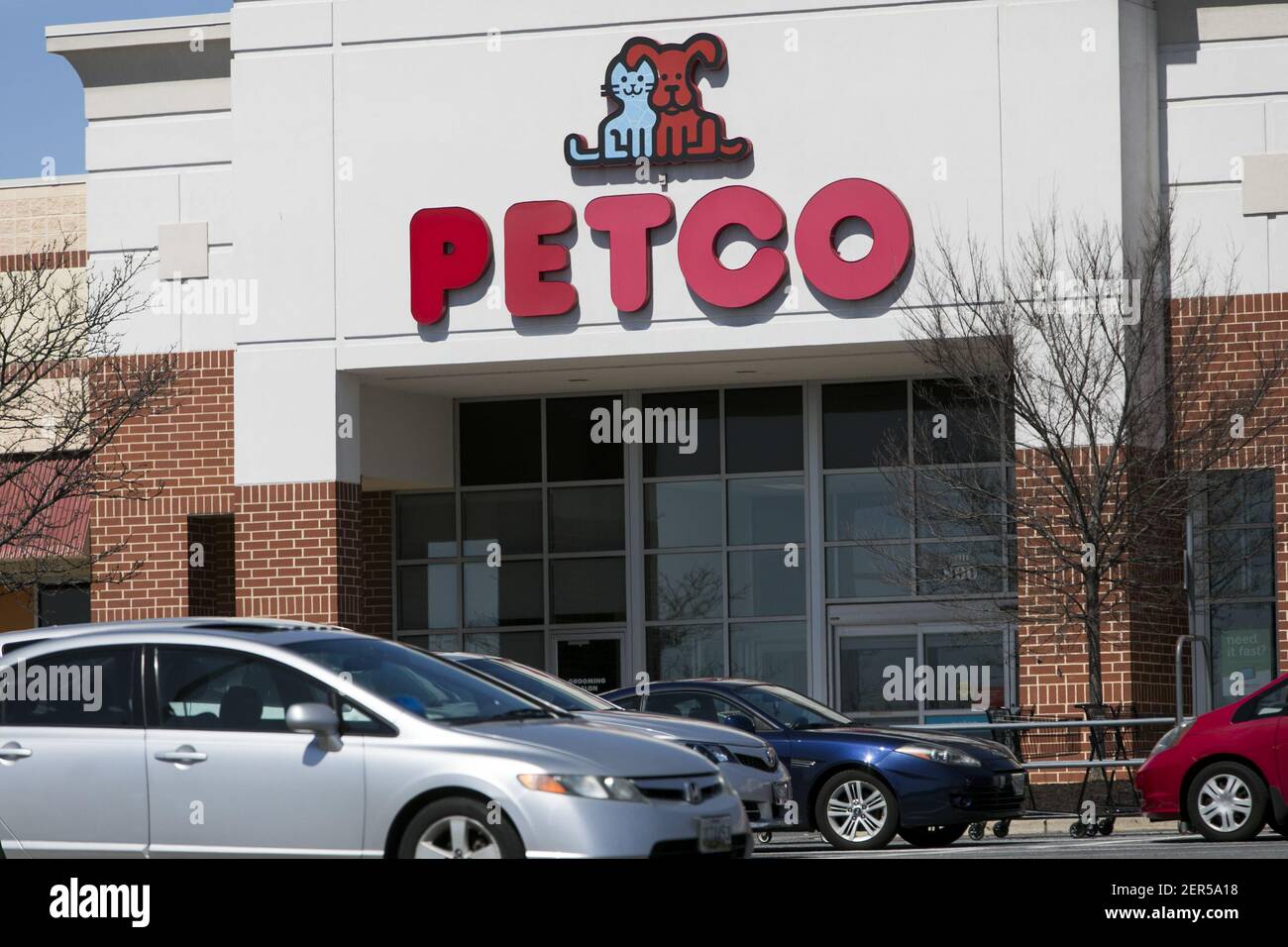 A logo sign outside of a Petco retail store location in Columbia ...