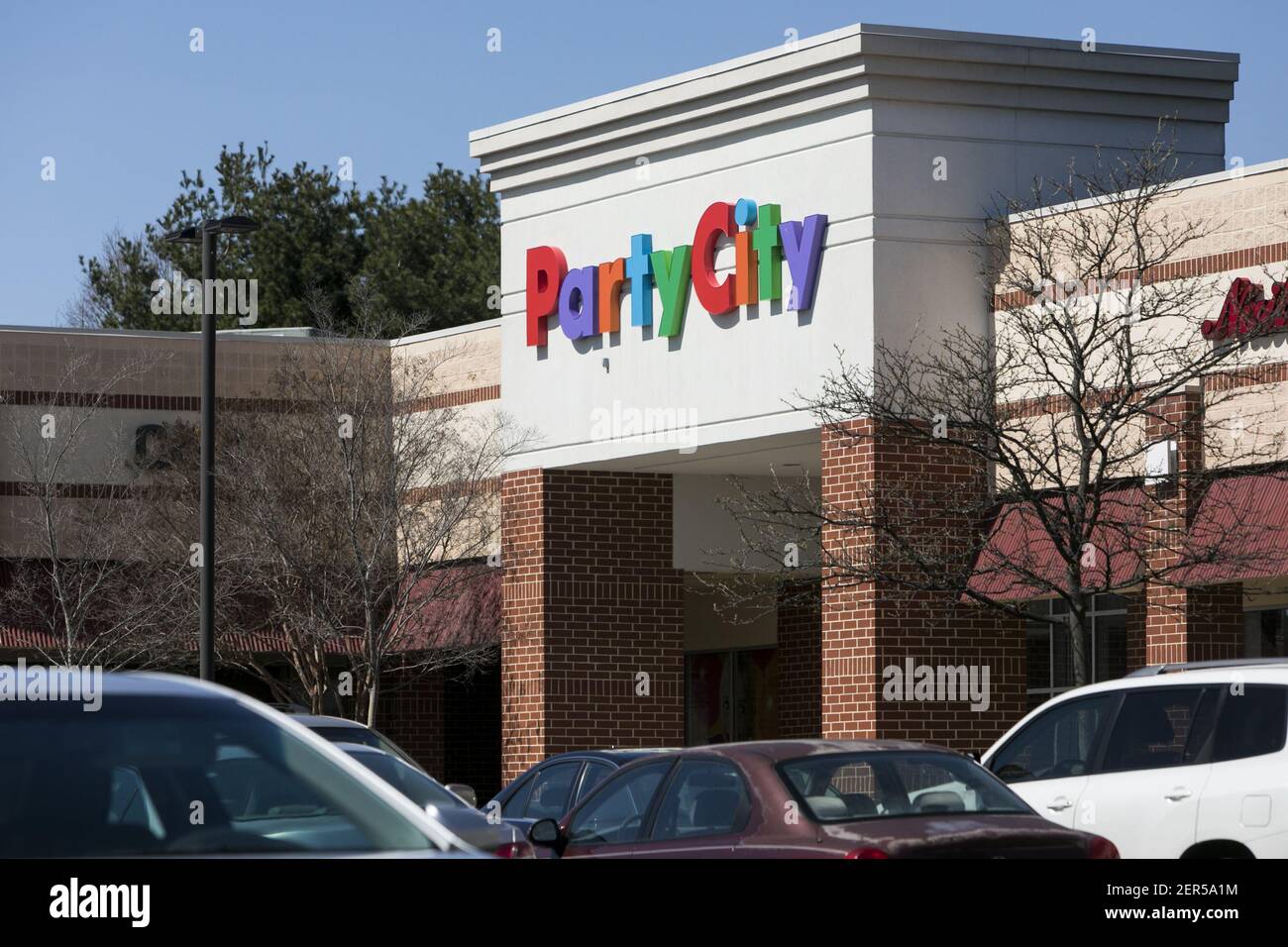 A logo sign outside of a Party City retail store location in Columbia ...
