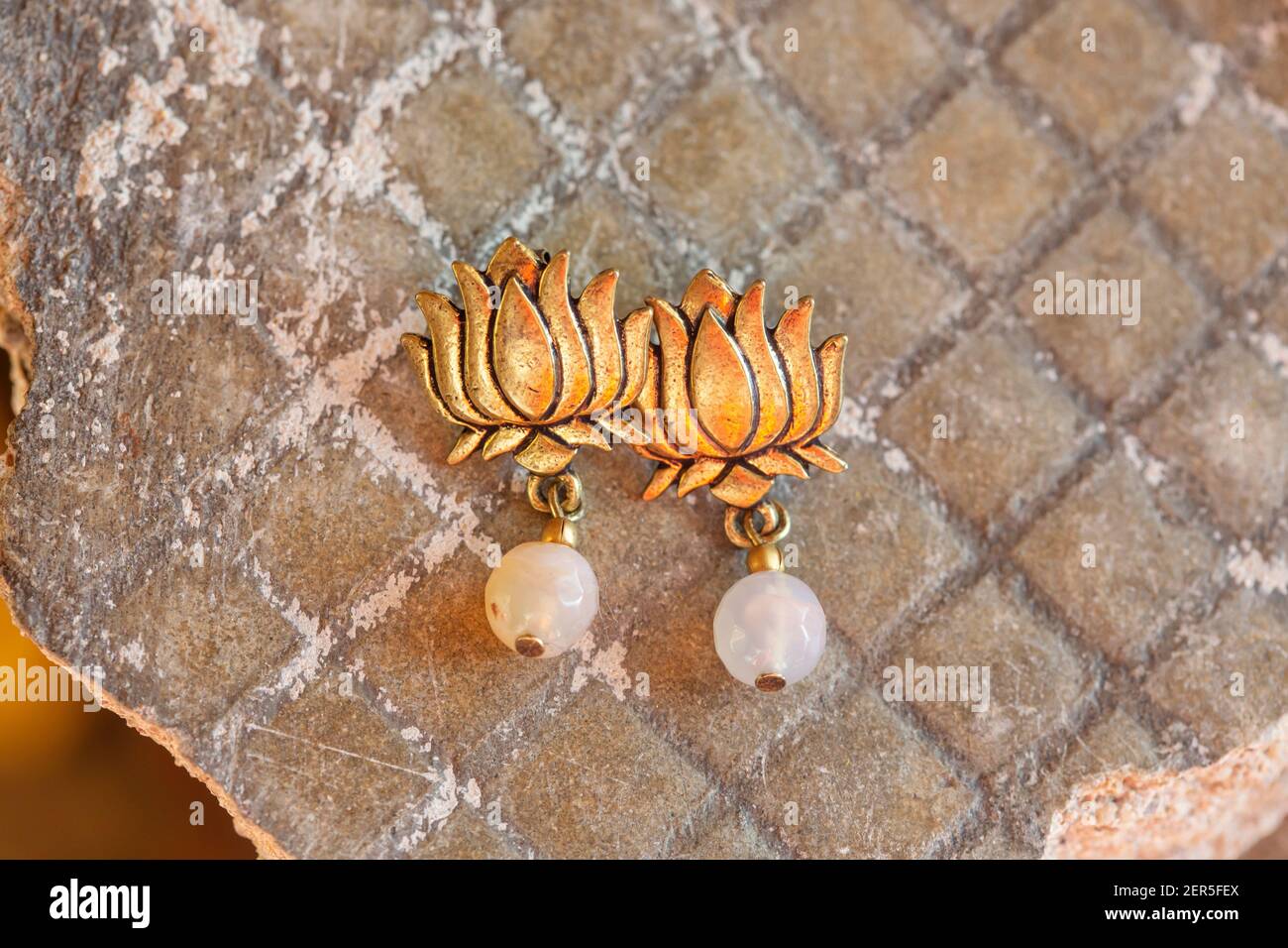 Lotus shape mineral stone earrings Stock Photo - Alamy