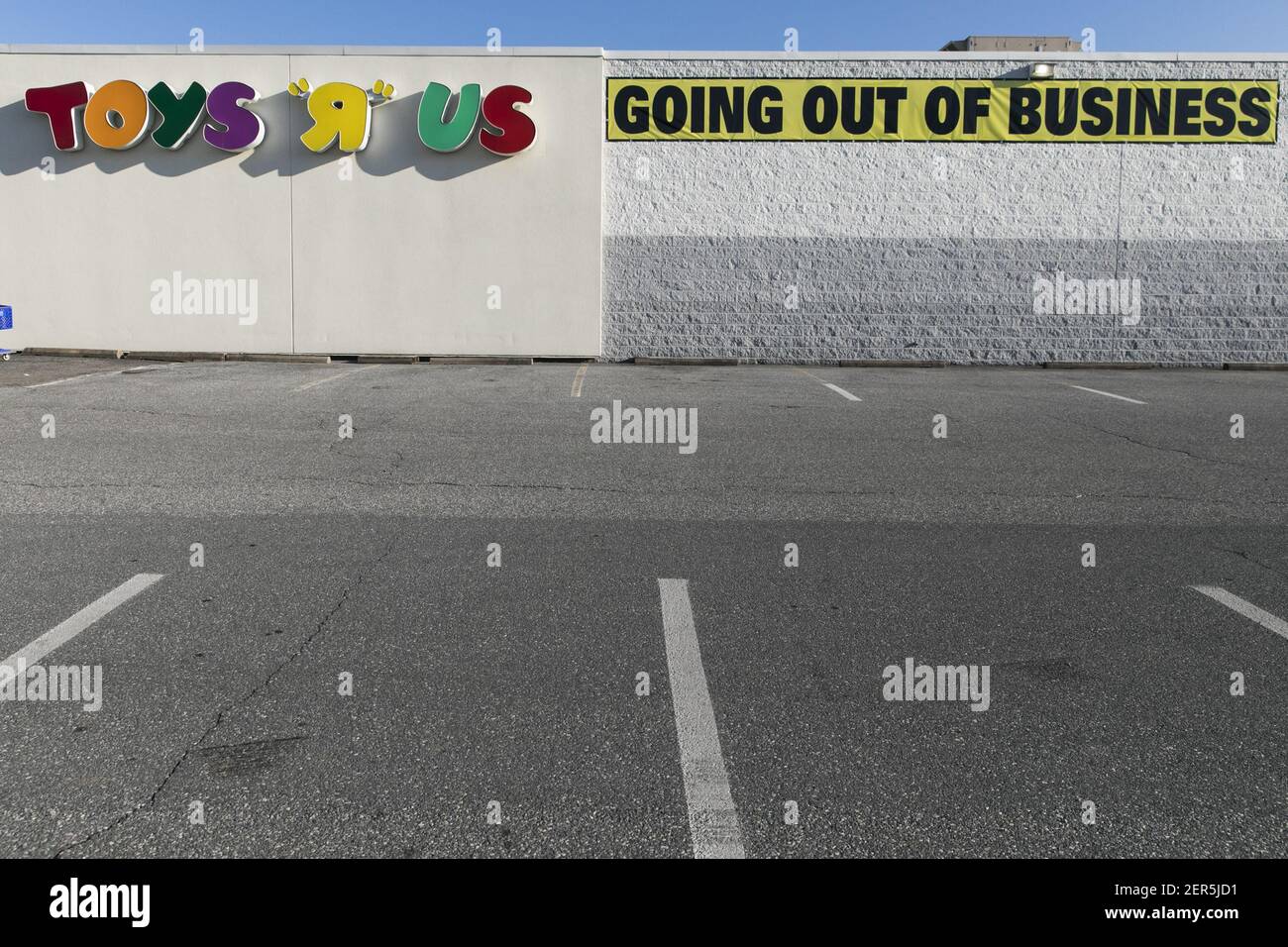 A logo sign outside of a Toys "R" Us retail store in Lancaster ...