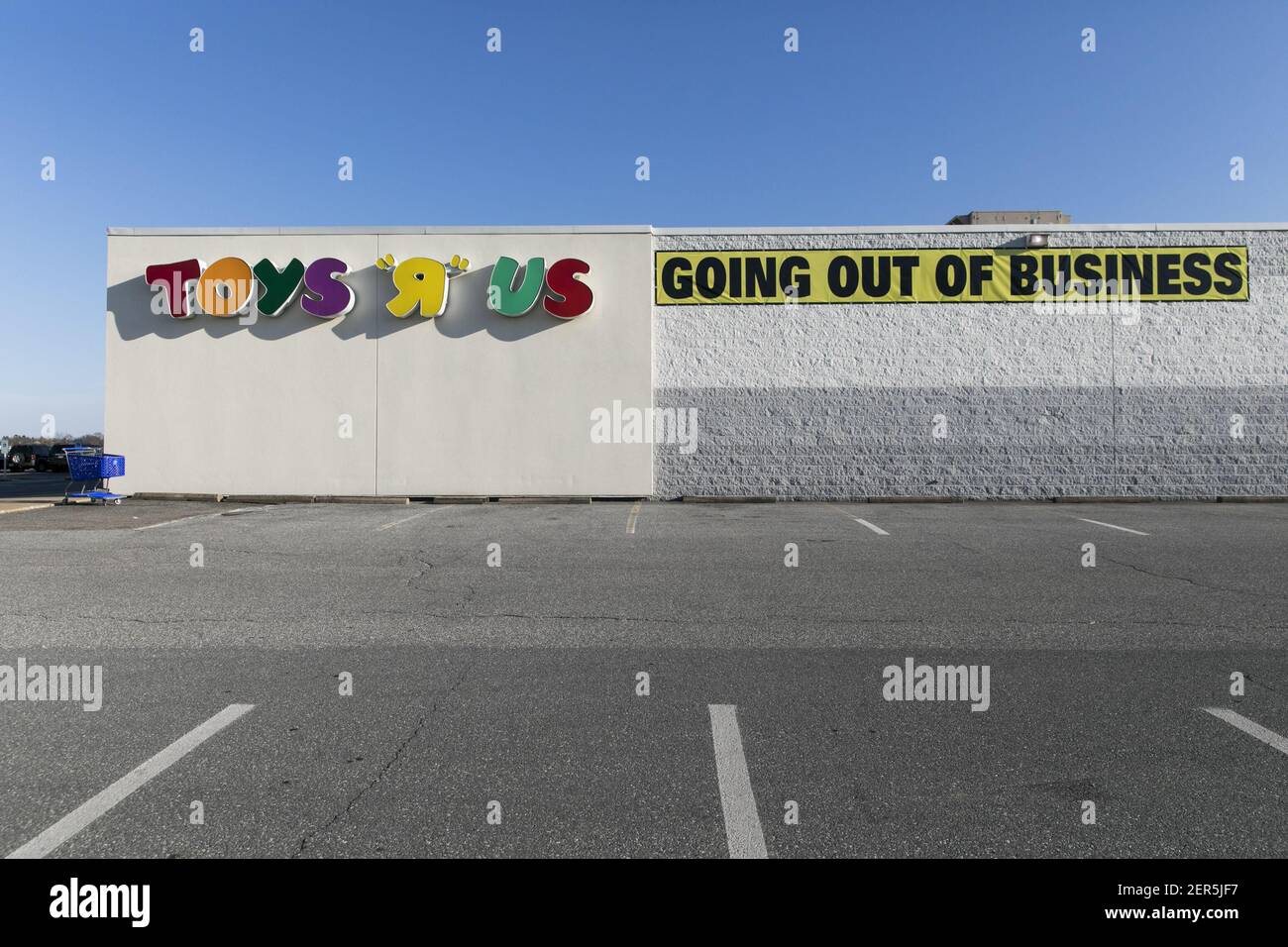 A logo sign outside of a Toys "R" Us retail store in Lancaster ...