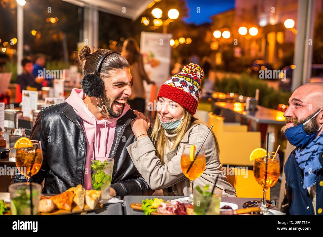 Couple drinking cocktail at bar in the night wearing face mask - New ...