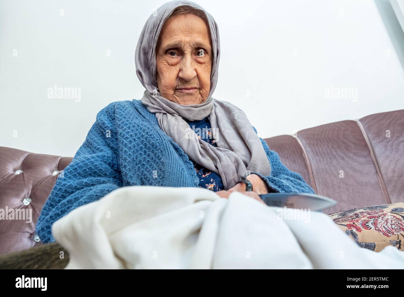 Muslim woman cutting piece of cloth with scissor Stock Photo - Alamy