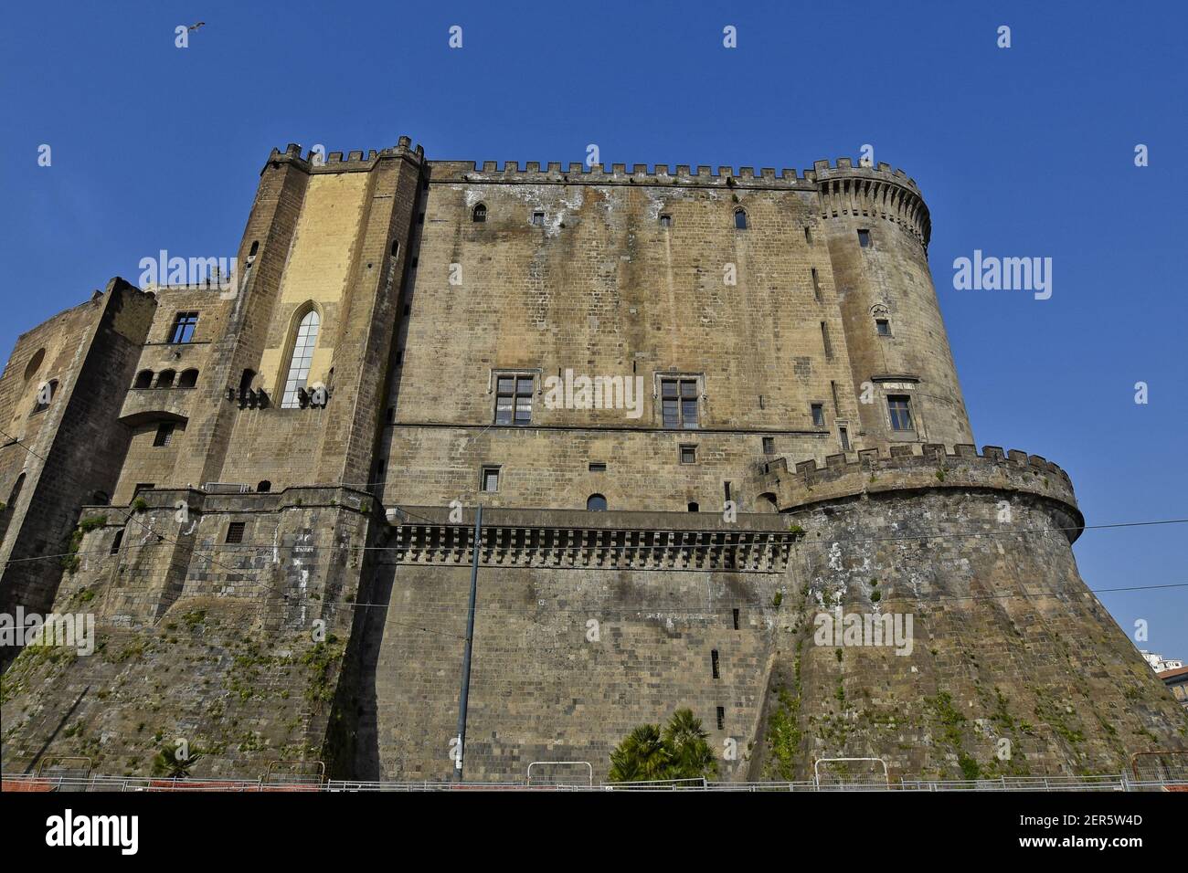 The walls and towers of a medieval castle in the old town of Naples ...