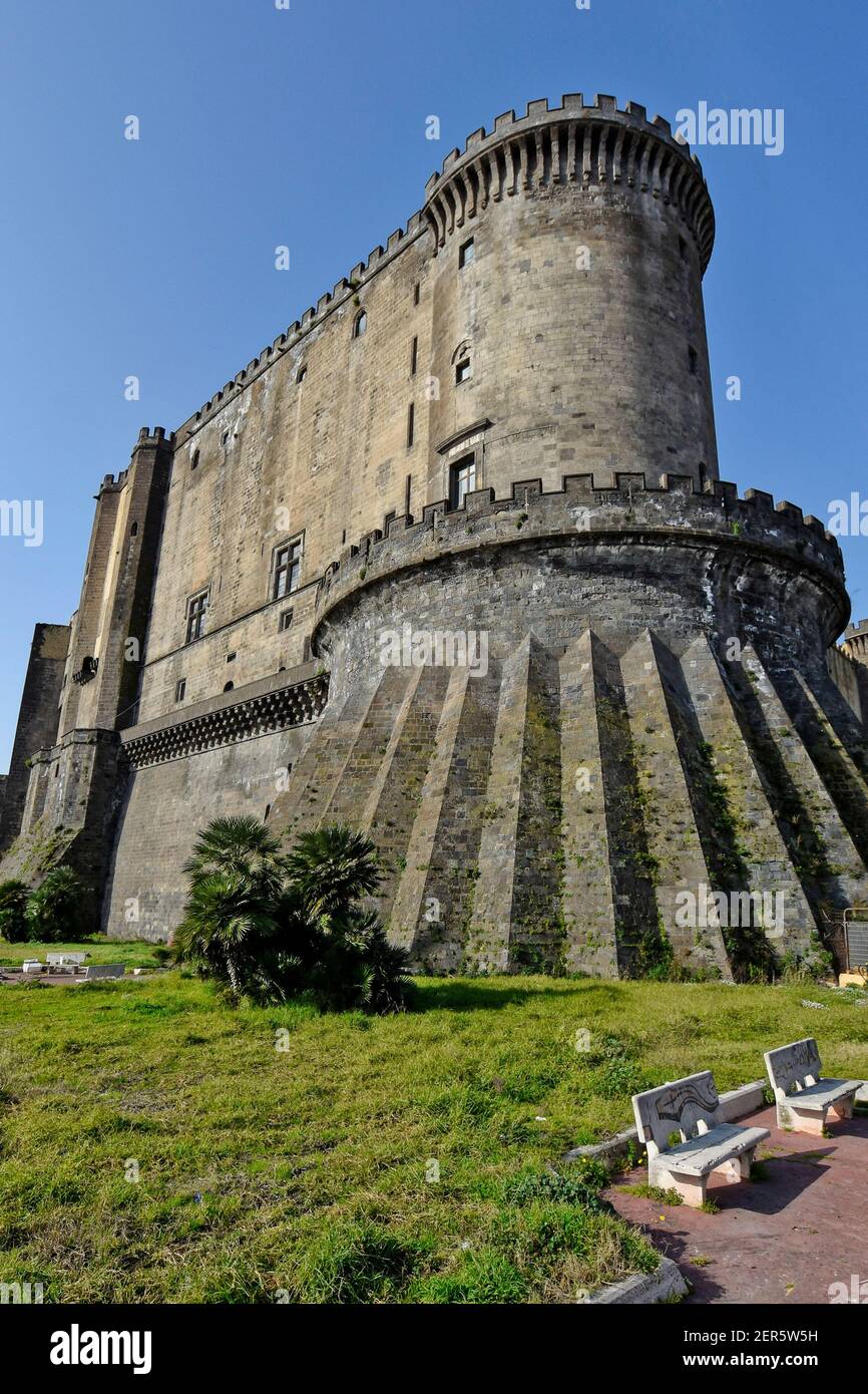 The walls and towers of a medieval castle in the old town of Naples ...