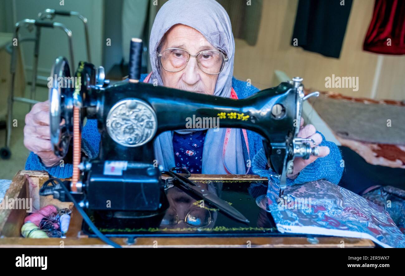 Arabic muslim old woman using old sewing machine Stock Photo - Alamy