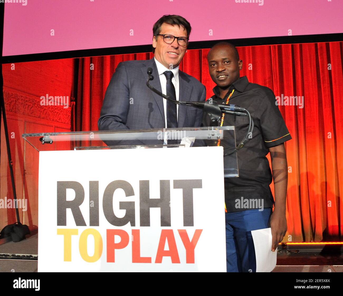 Right To Play founder Johann Olav Koss (L) presents the Right To Play ...