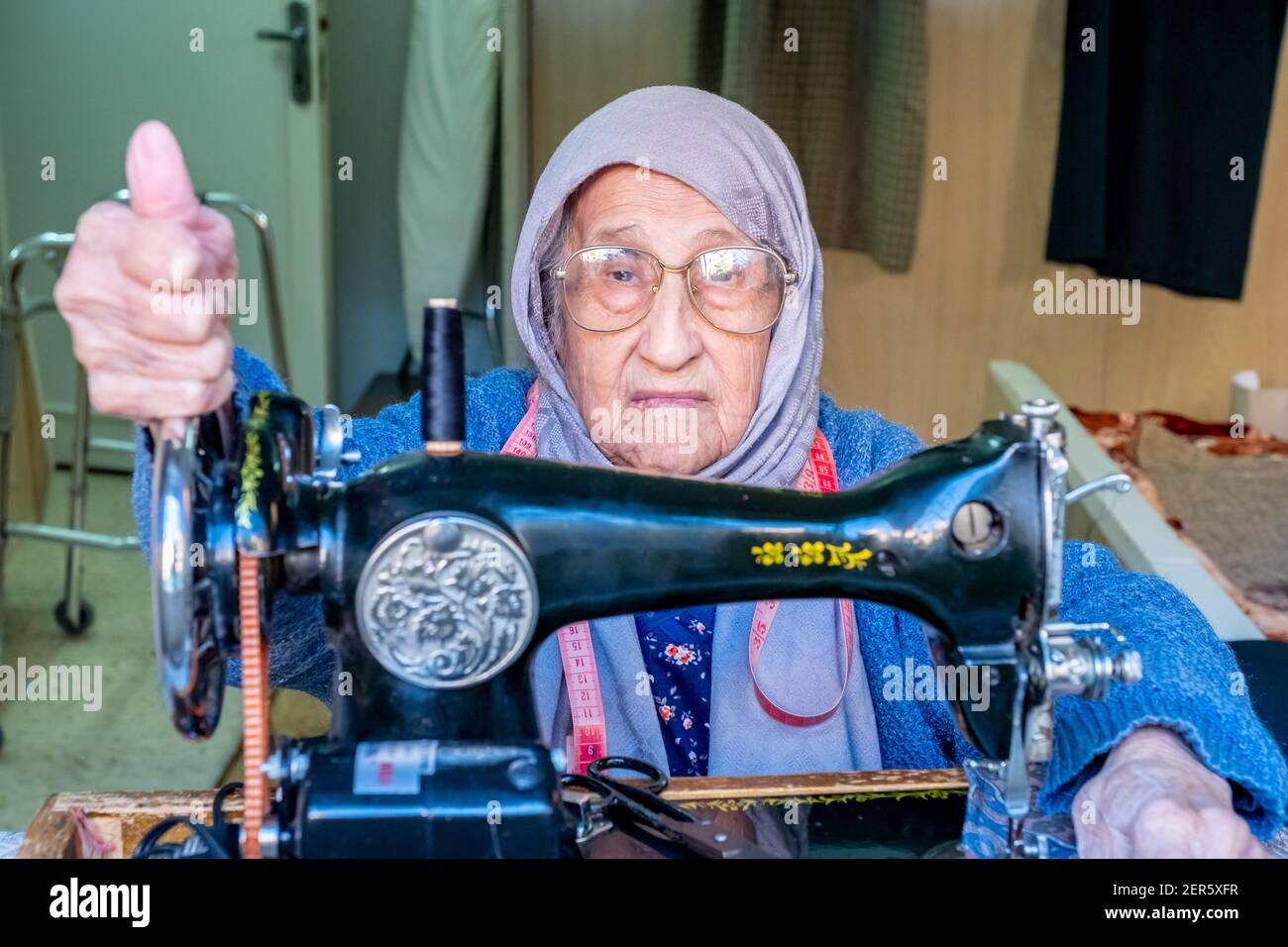 Arabic muslim old woman happy while using sewing machine Stock Photo ...