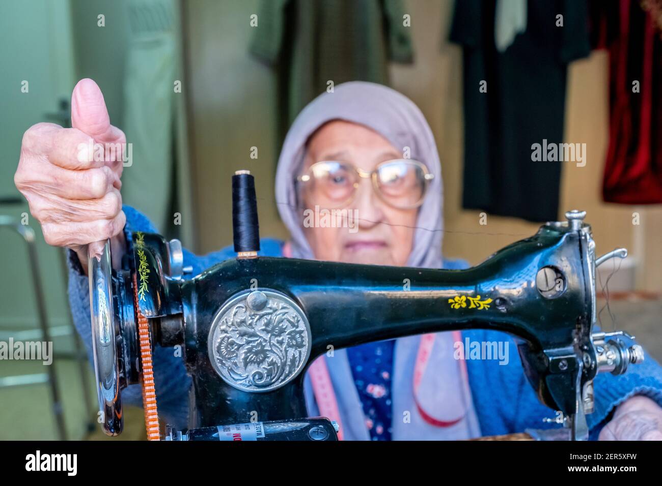 Arabic muslim old woman happy while using sewing machine Stock Photo ...