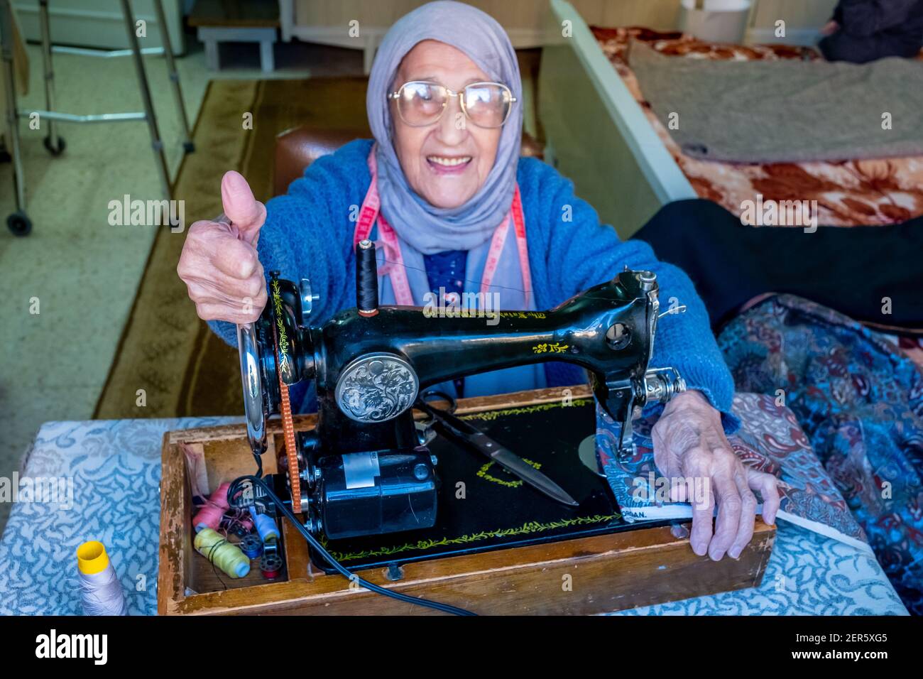 Arabic muslim old woman happy while using sewing machine Stock Photo ...