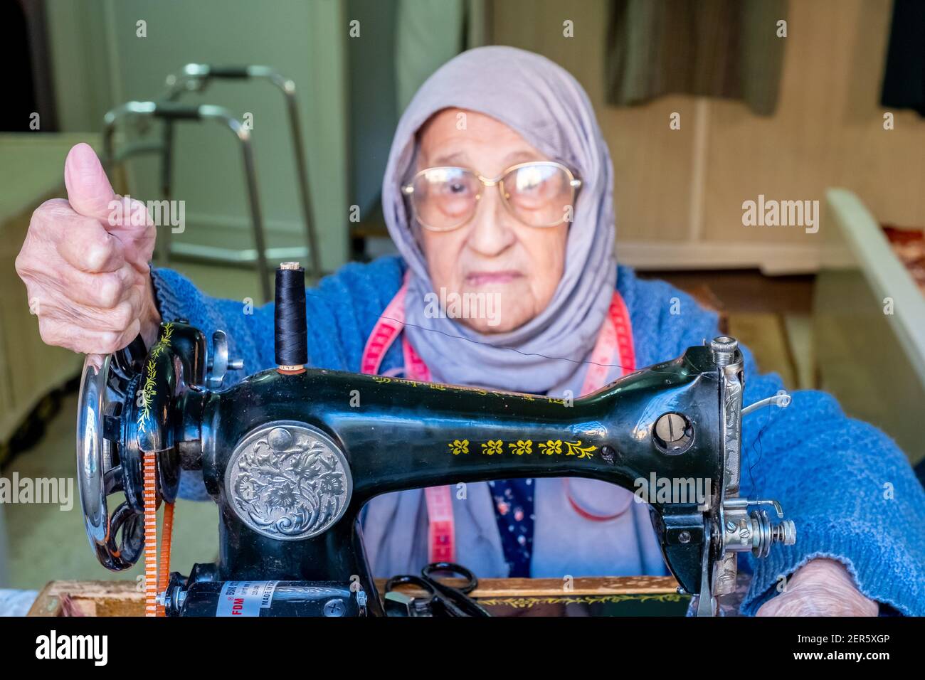 Arabic muslim old woman happy while using sewing machine Stock Photo ...