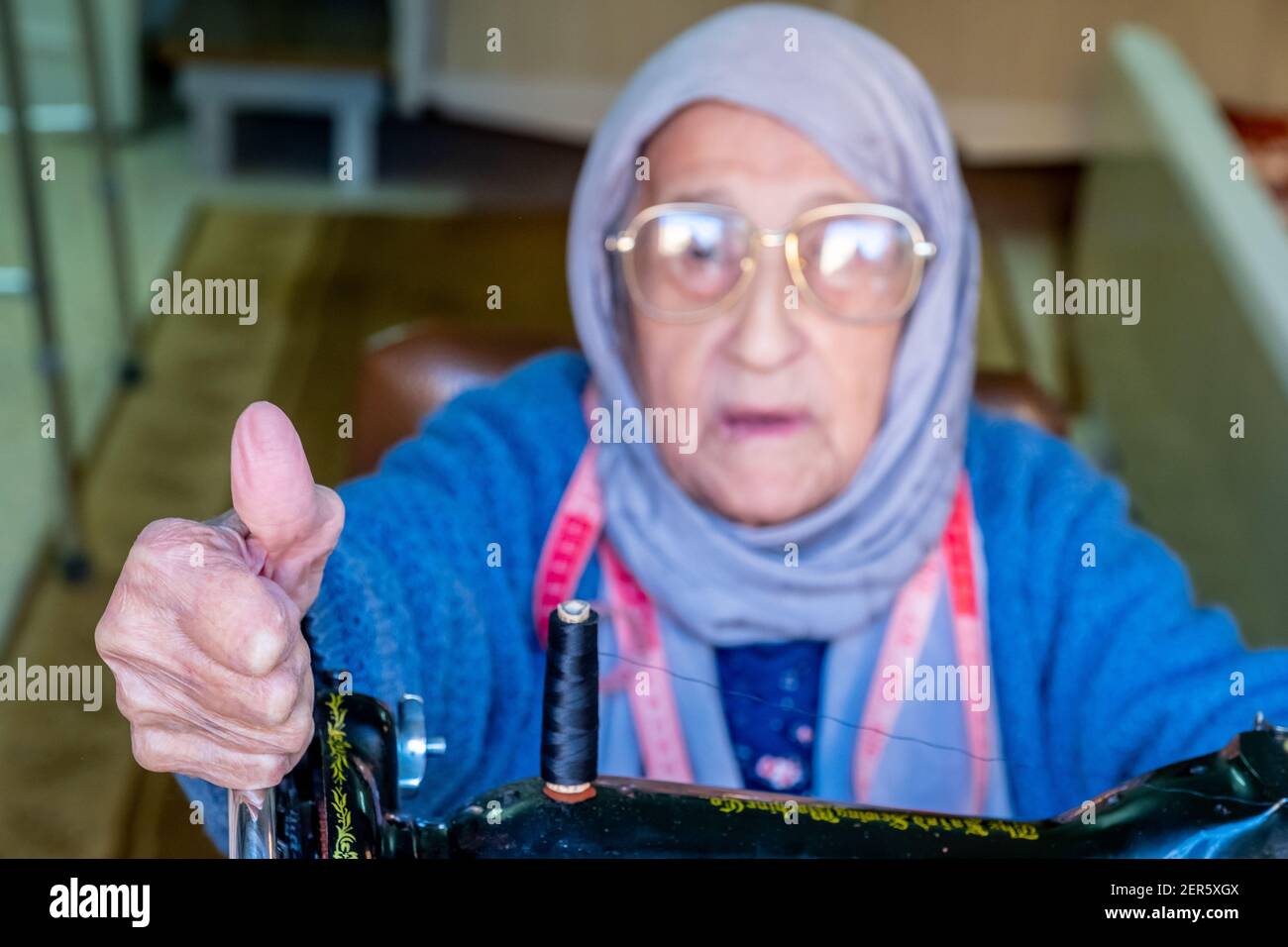 Arabic muslim old woman happy while using sewing machine Stock Photo ...