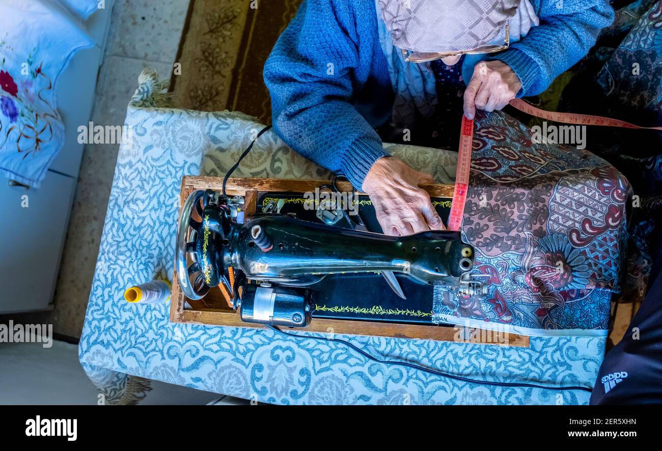 Arabic muslim woman sewing and measuring lengths with her tape Stock ...