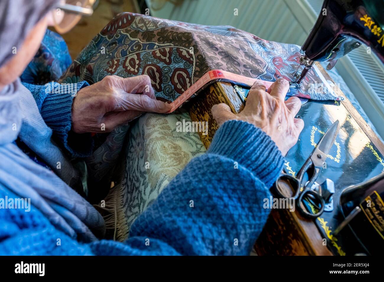 Arabic muslim woman sewing and measuring lengths with her tape Stock ...