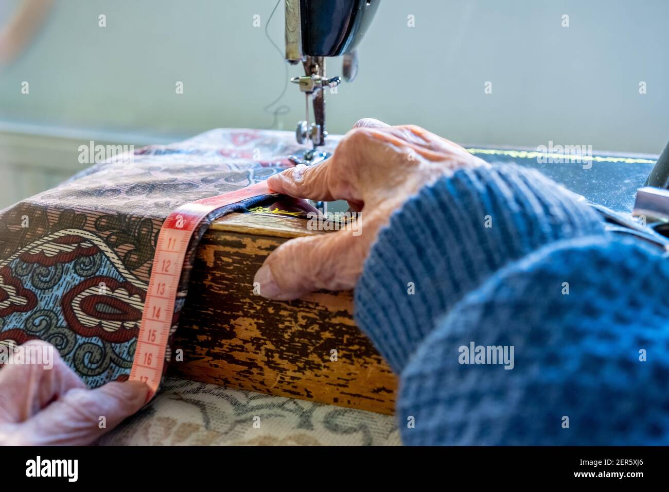 Arabic muslim woman sewing and measuring lengths with her tape Stock ...