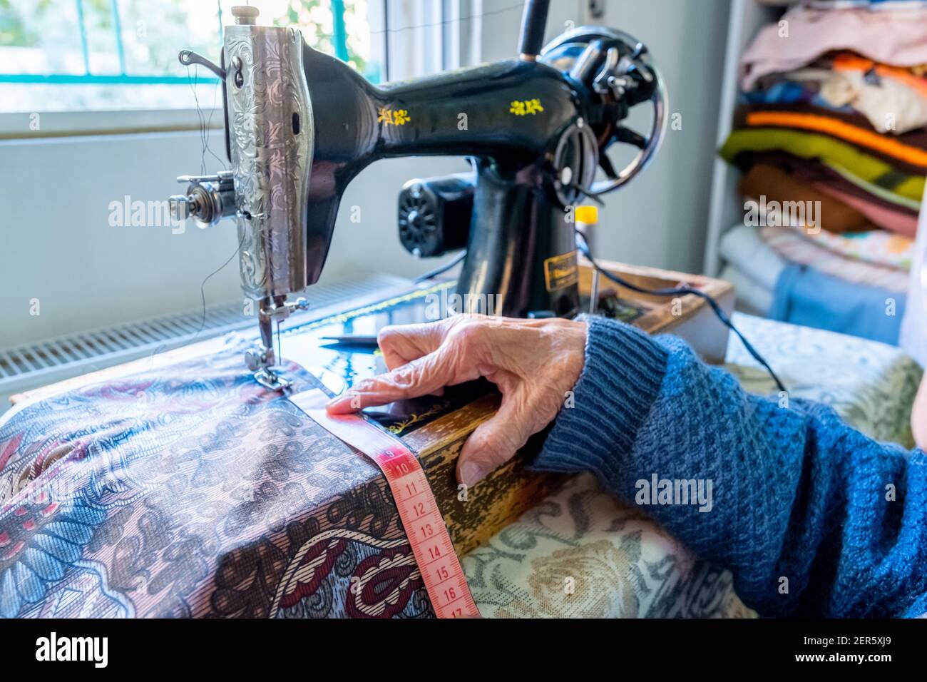 Arabic muslim woman sewing and measuring lengths with her tape Stock ...