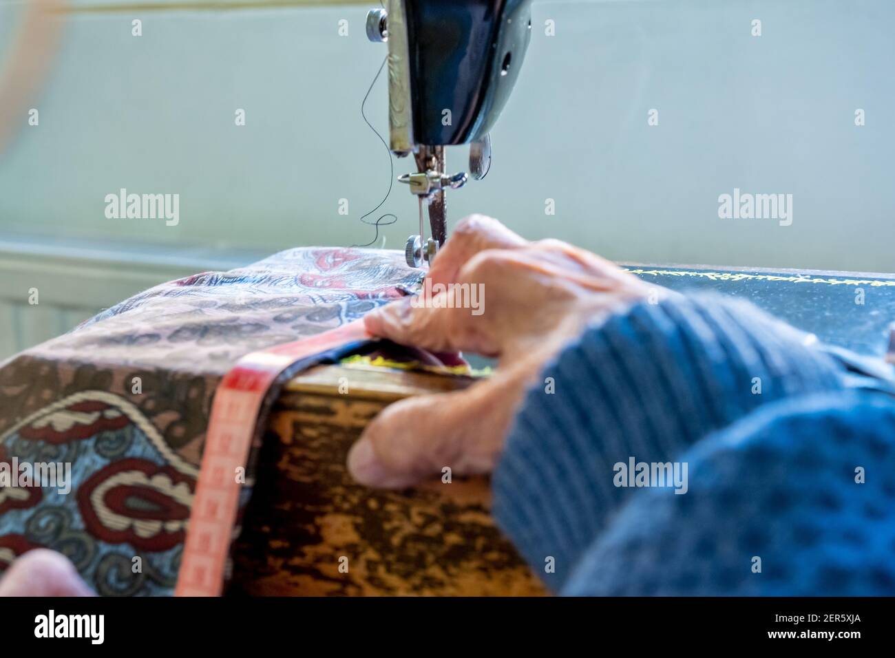 Arabic muslim woman sewing and measuring lengths with her tape Stock ...