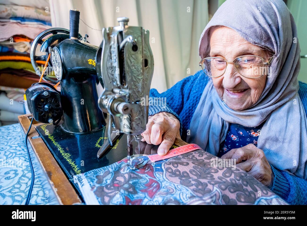Arabic muslim woman sewing and measuring lengths with her tape Stock ...