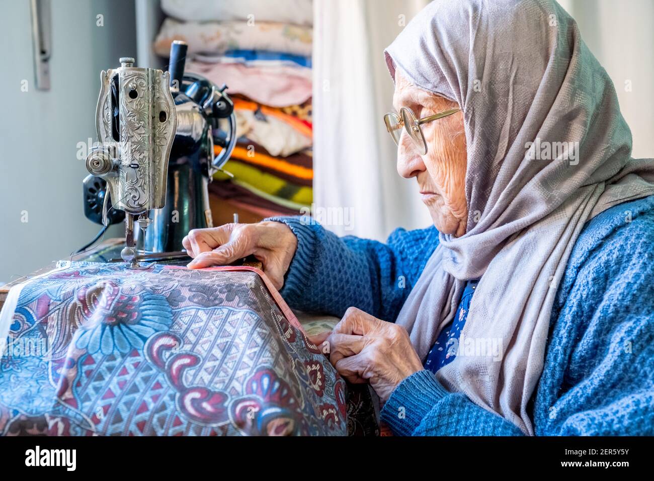 Arabic muslim woman sewing and measuring lengths with her tape Stock ...