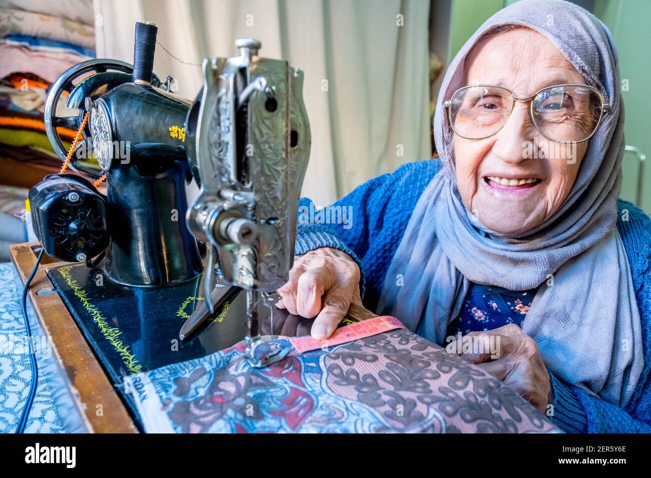 Arabic muslim woman sewing and measuring lengths with her tape Stock ...