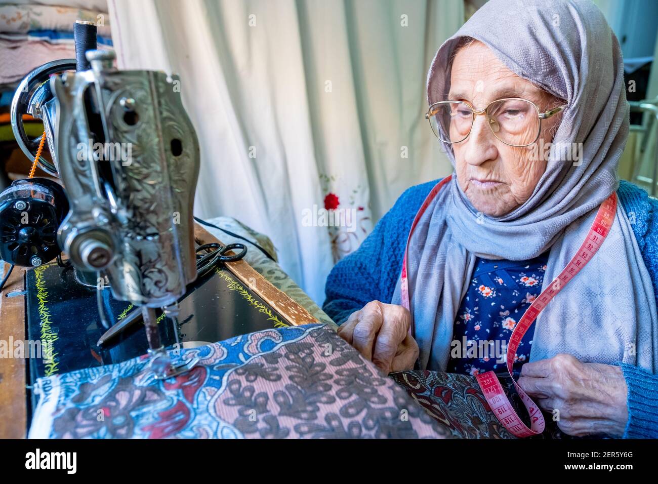 Arabic muslim woman sewing and measuring lengths with her tape Stock ...