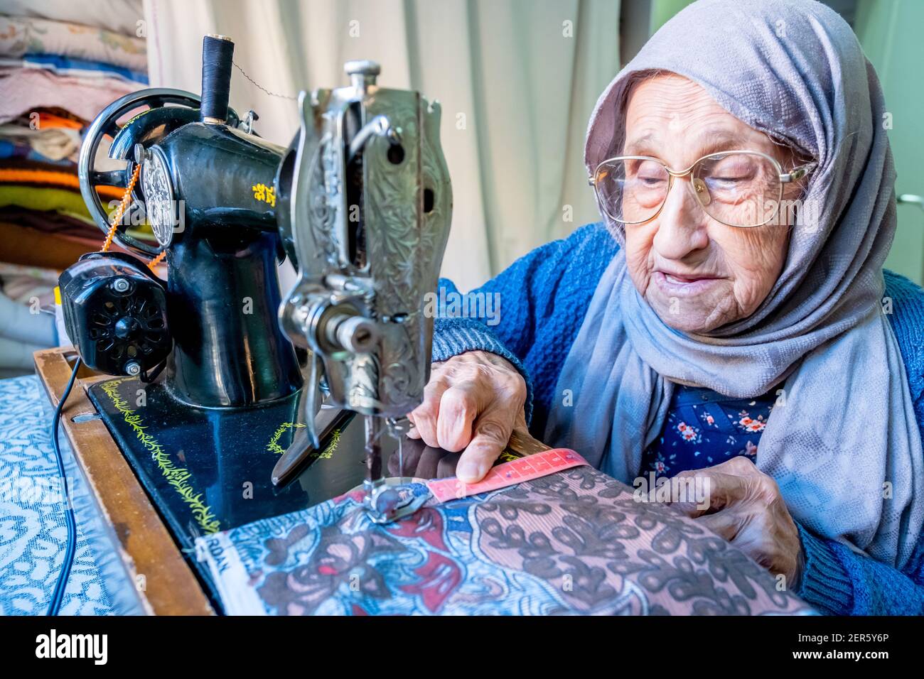 Arabic muslim woman sewing and measuring lengths with her tape Stock ...