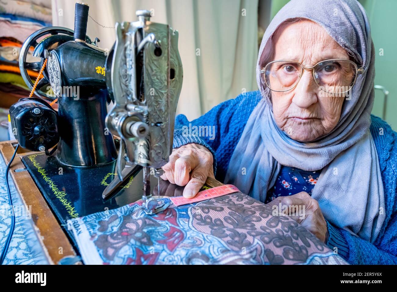 Arabic muslim woman sewing and measuring lengths with her tape Stock ...