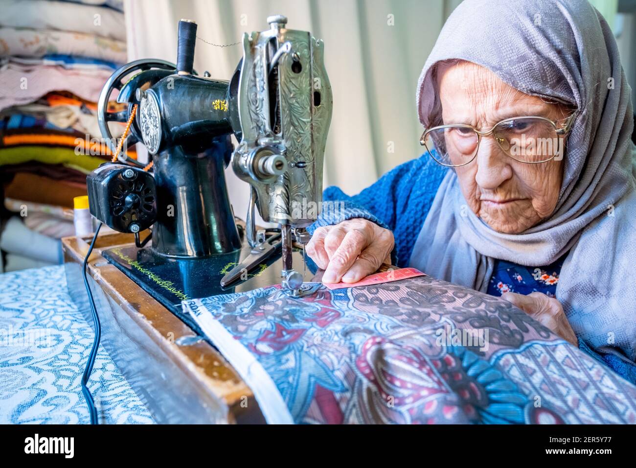 Arabic muslim woman sewing and measuring lengths with her tape Stock ...