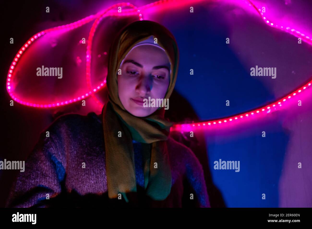 Arabic muslim girl with beatiful colored lights behind her Stock Photo ...