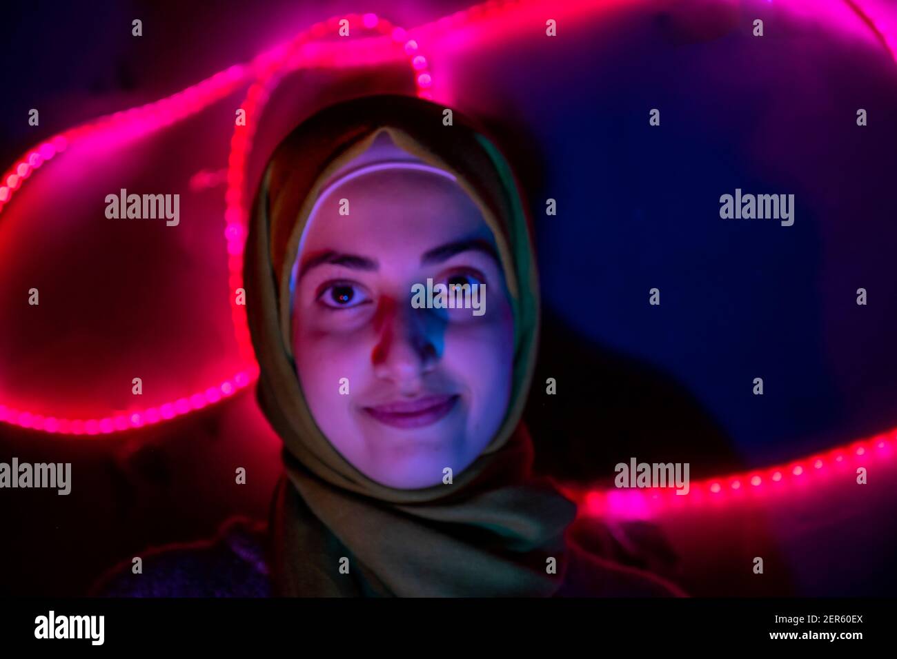 Arabic muslim girl with beatiful colored lights behind her Stock Photo ...