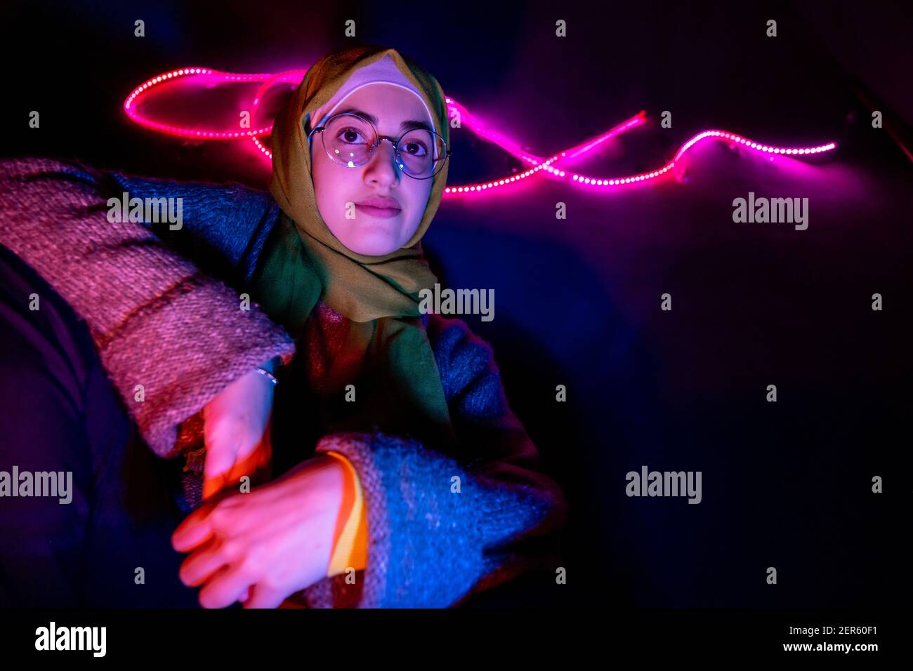 Arabic muslim girl with beatiful colored lights behind her Stock Photo ...