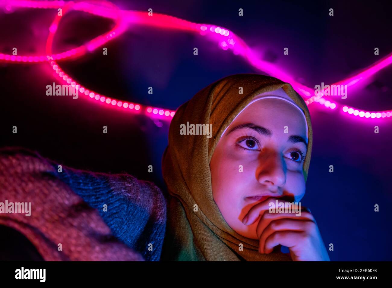 Arabic muslim girl with beatiful colored lights behind her Stock Photo ...
