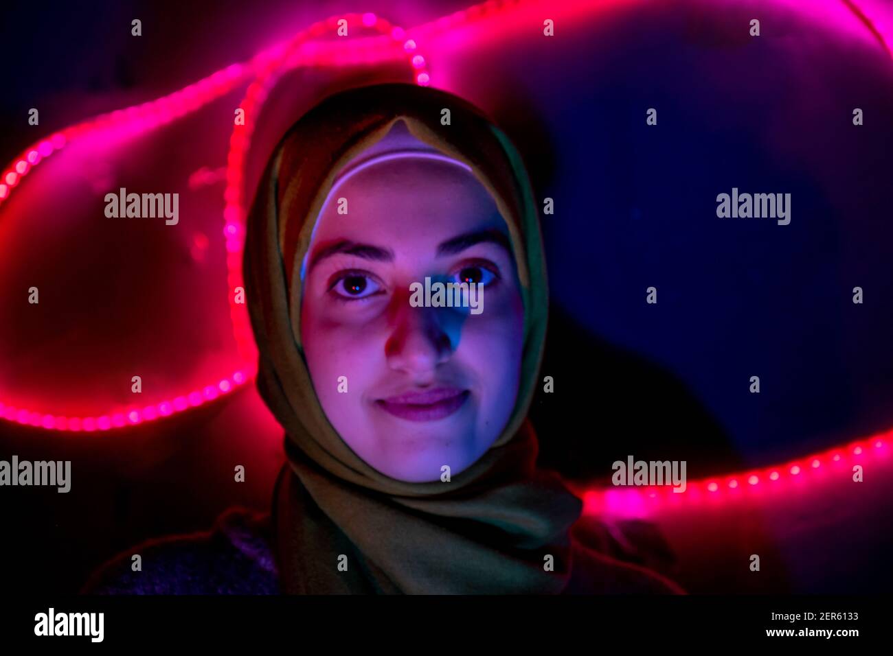 Arabic muslim girl with beatiful colored lights behind her Stock Photo ...