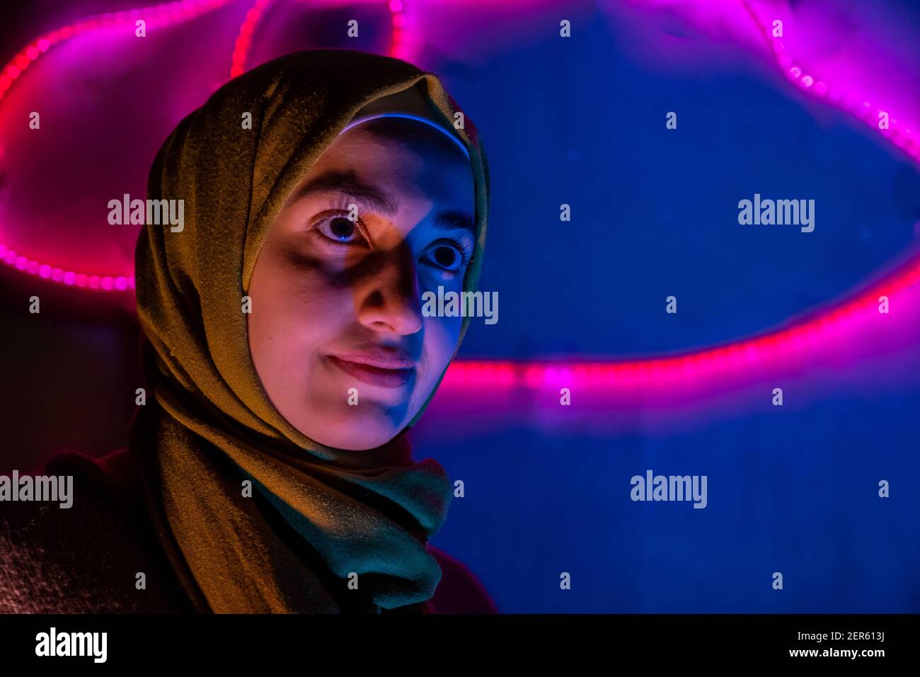 Arabic muslim girl with beatiful colored lights behind her Stock Photo ...
