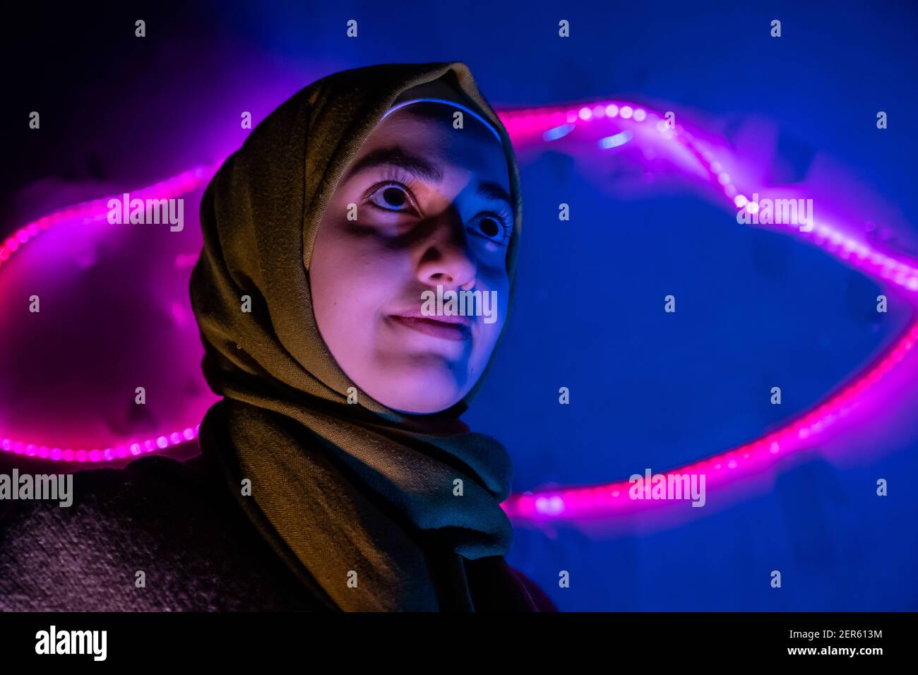 Arabic muslim girl with beatiful colored lights behind her Stock Photo ...