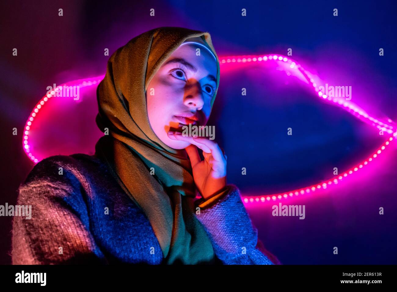 Arabic muslim girl with beatiful colored lights behind her Stock Photo ...