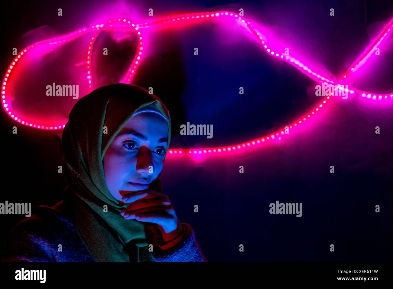 Arabic muslim girl with beatiful colored lights behind her Stock Photo ...