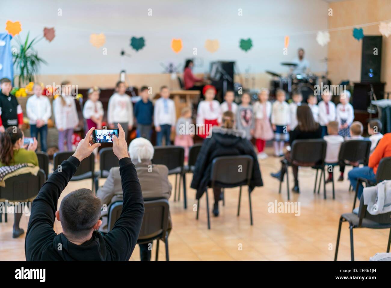 Parents at the performance of children in kindergarten or school ...