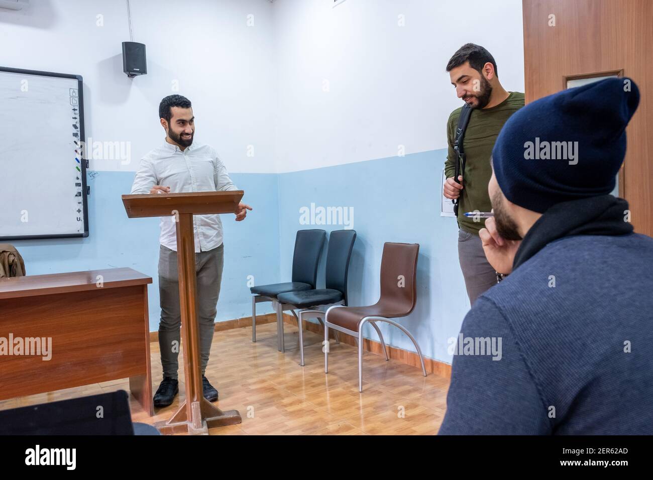 Arabic student coming late to class Stock Photo - Alamy
