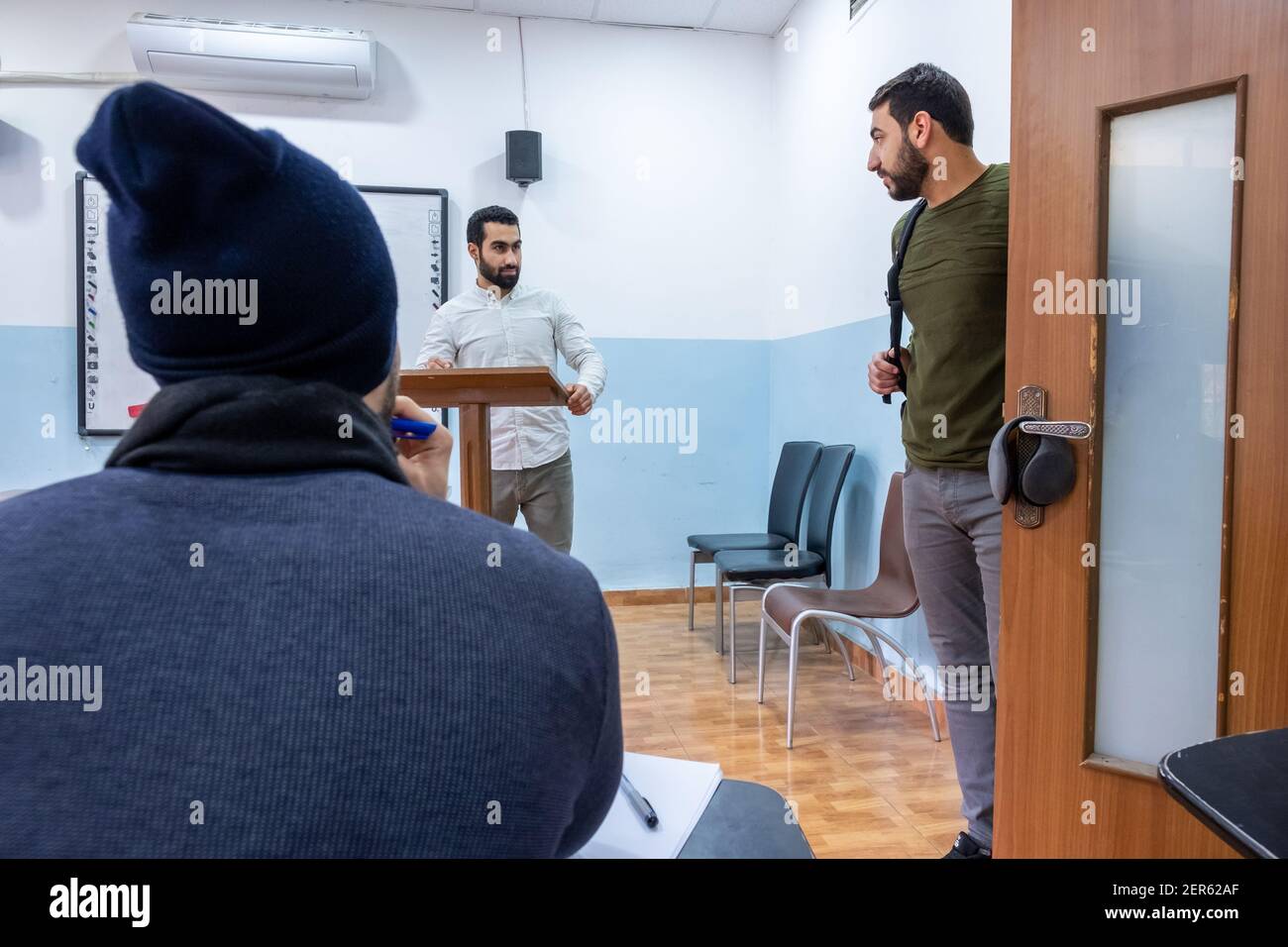 Arabic student coming late to class Stock Photo - Alamy