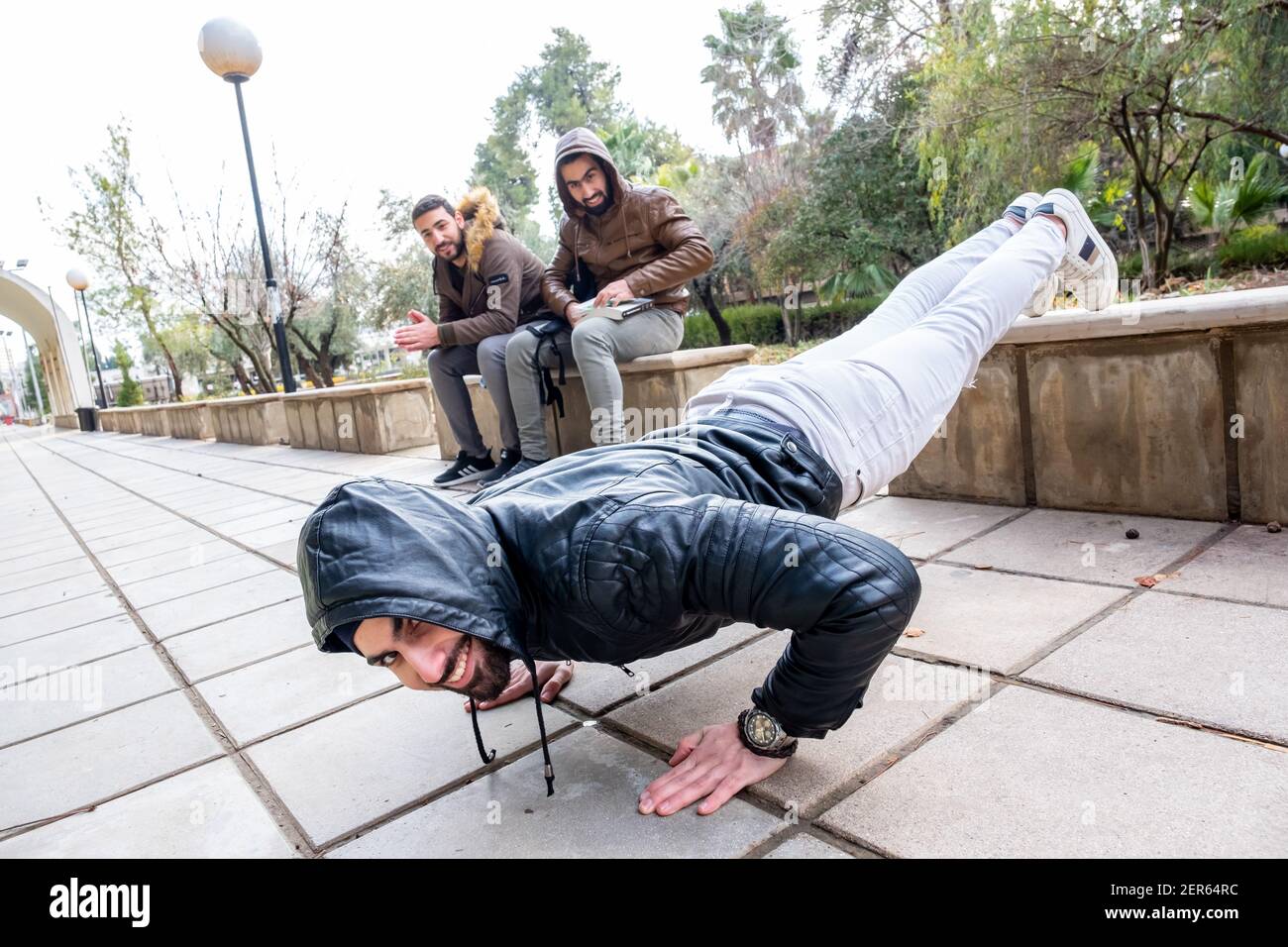 Arabic muslim guy doing pushups at campus Stock Photo - Alamy