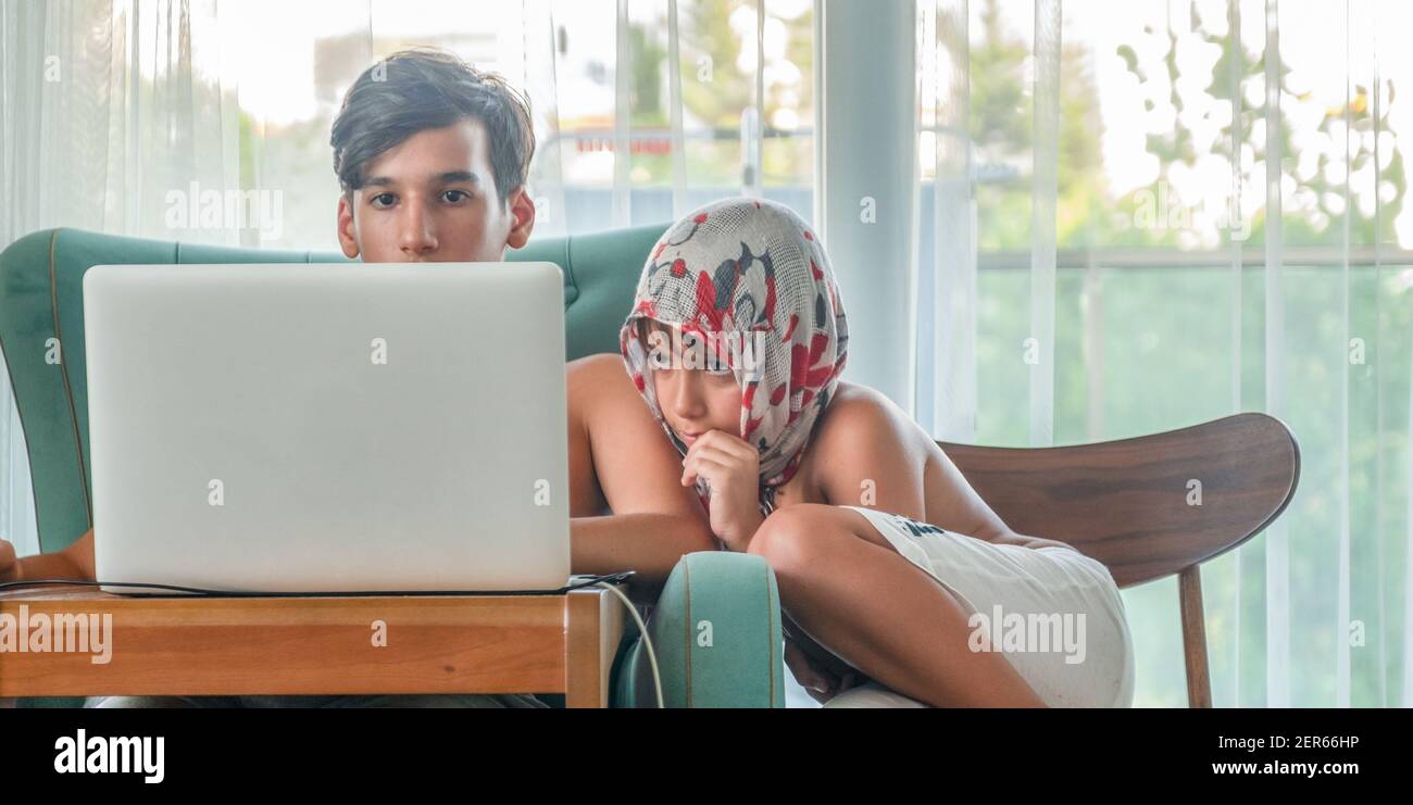 Arabic boy playing on laptop Stock Photo - Alamy
