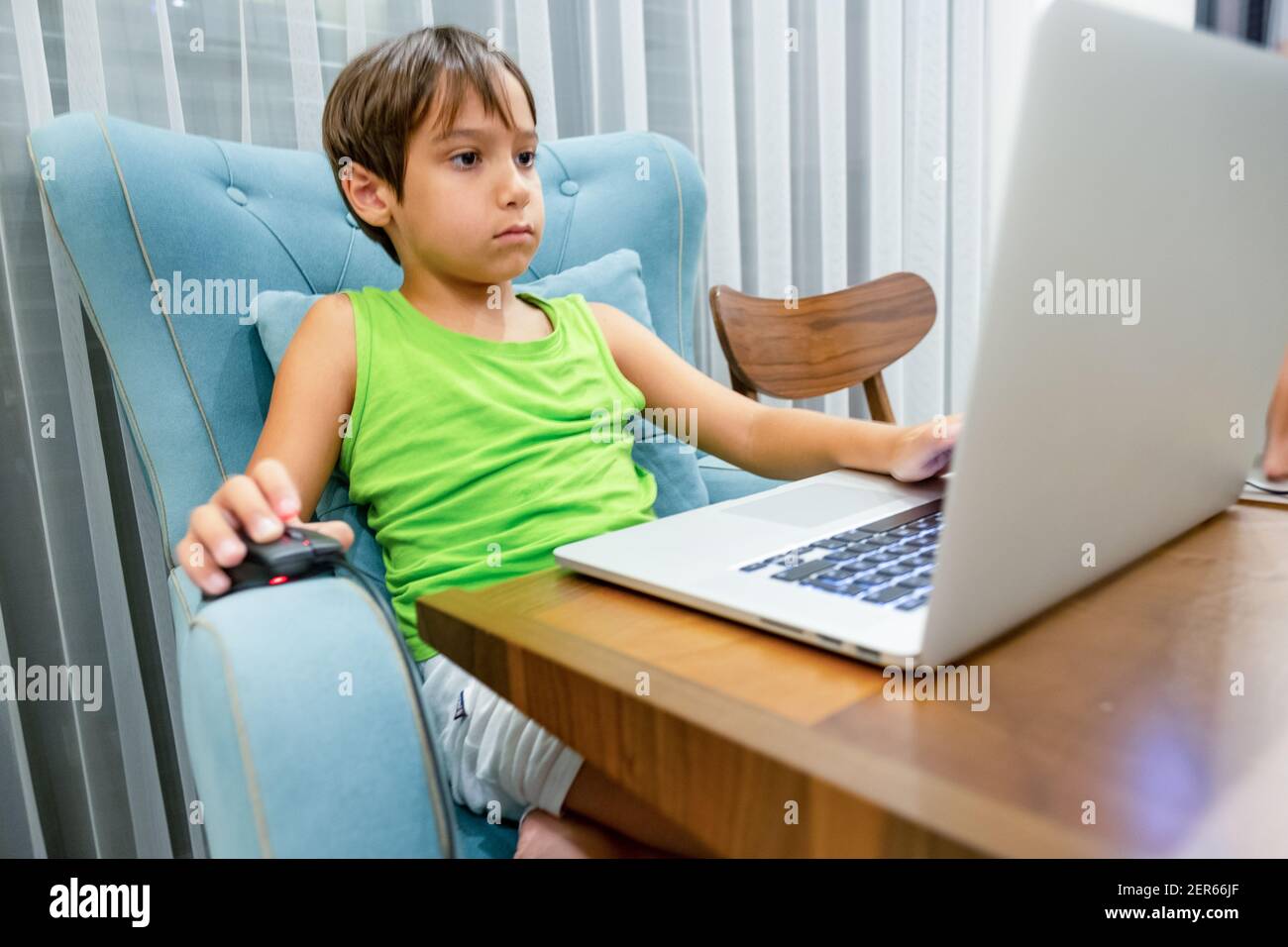 Arabic boy playing on laptop Stock Photo - Alamy