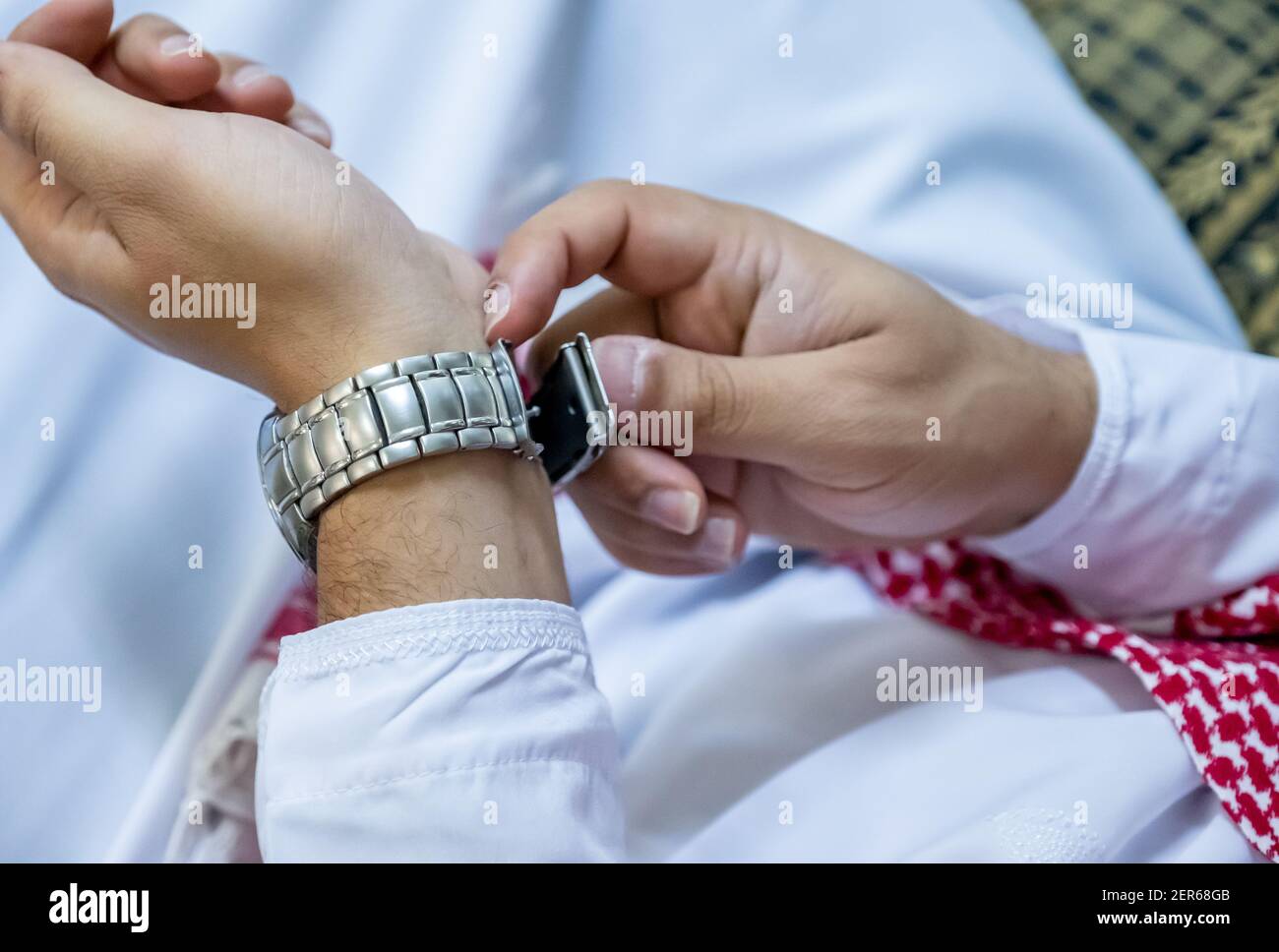 Arabic muslim man trying his new watch Stock Photo - Alamy