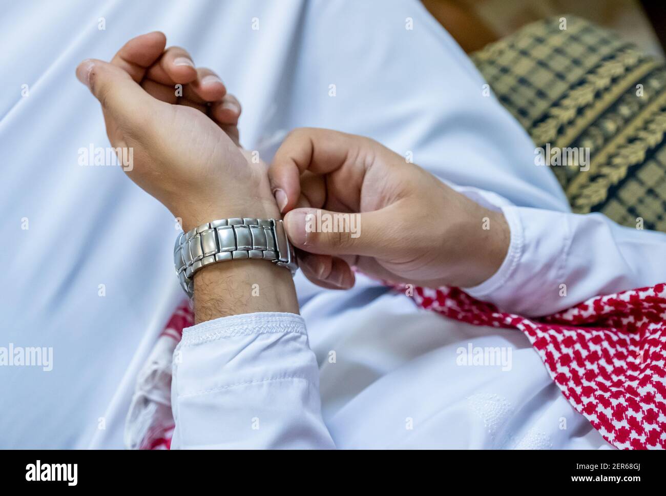 Arabic muslim man trying his new watch Stock Photo - Alamy